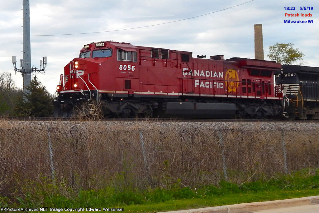 AC44CWM 8056 leads potash loads up the hill near Holt Av.